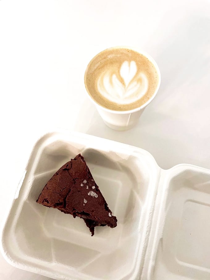 Chocolate cake so rich it probably has its own accountant. The perfect ratio of dense brownie texture meets coffee artistry.