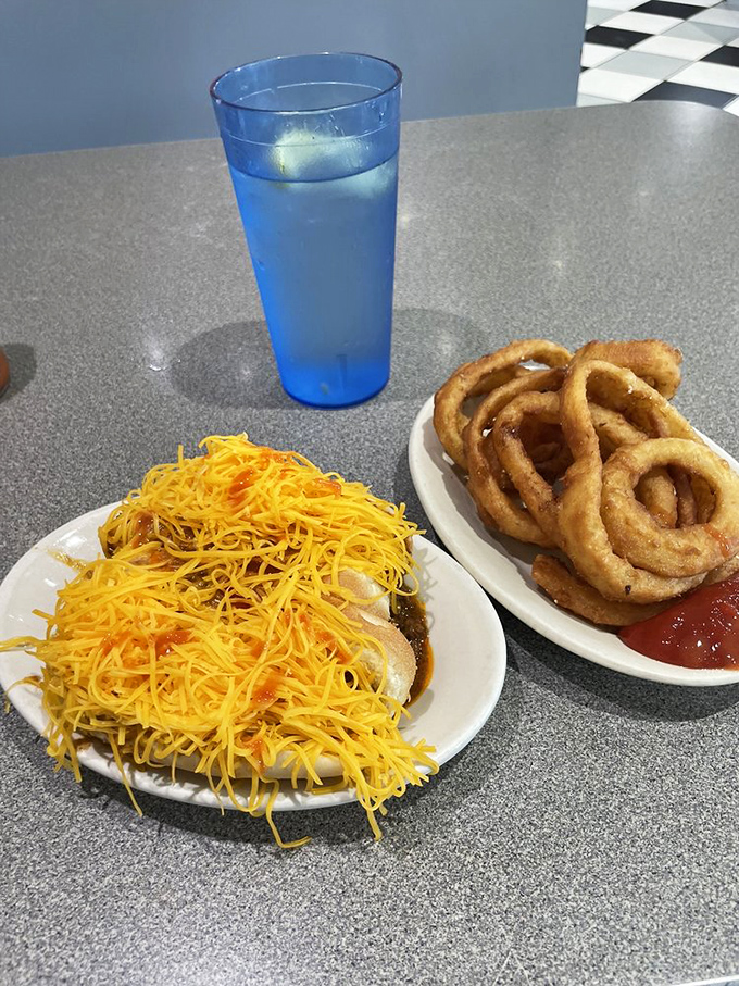 The dynamic duo &ndash; cheese coneys with a side of onion rings and that signature finely-shredded cheddar that defines Cincinnati chili