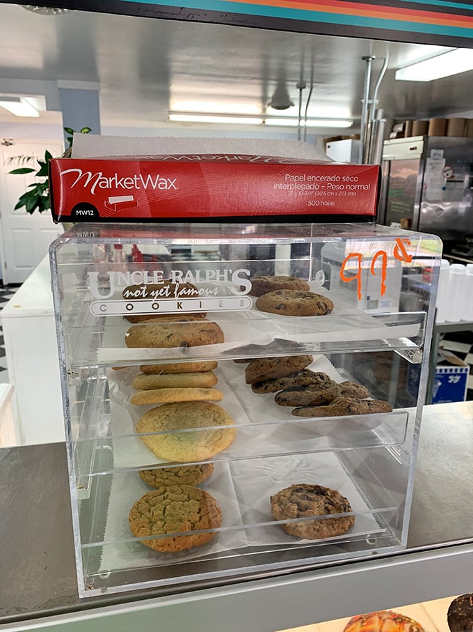 Cookie display that's basically a museum of deliciousness. Each one perfectly positioned, silently judging lesser desserts from their clear-walled palace.