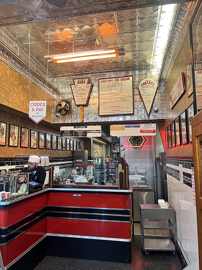 Art deco meets dairy perfection beneath a gleaming tin ceiling. This isn't just an ice cream counter&mdash;it's dessert's hallowed ground.