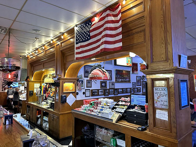 The American flag watches over a bar that's seen generations come and go. This wooden counter has heard more Oklahoma stories than most history books.