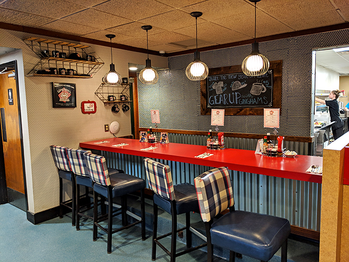 The counter seating area features gingham-patterned upholstery &ndash; a thoughtful nod to the restaurant's namesake fabric.