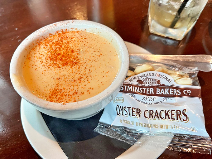 This crab bisque, sprinkled with paprika like a sunset over the ocean, makes oyster crackers feel like they've finally found their purpose.