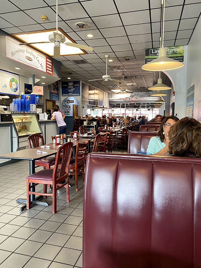 The dining room hums with the satisfied murmurs of patrons deep in sandwich bliss. Red booths: the universal signal for "good eating ahead."