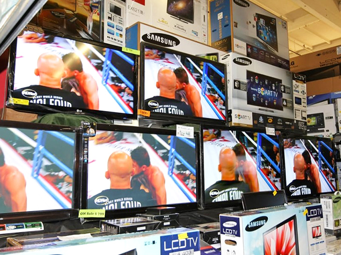 Electronics displays create walls of screens, a testament to our digital age. Even in this traditional marketplace, technology finds its place among handcrafted goods.