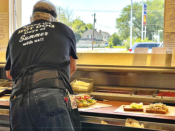The shirt says "Hot Dog Days of Summer," but the dedication says "quality food every day of the year."