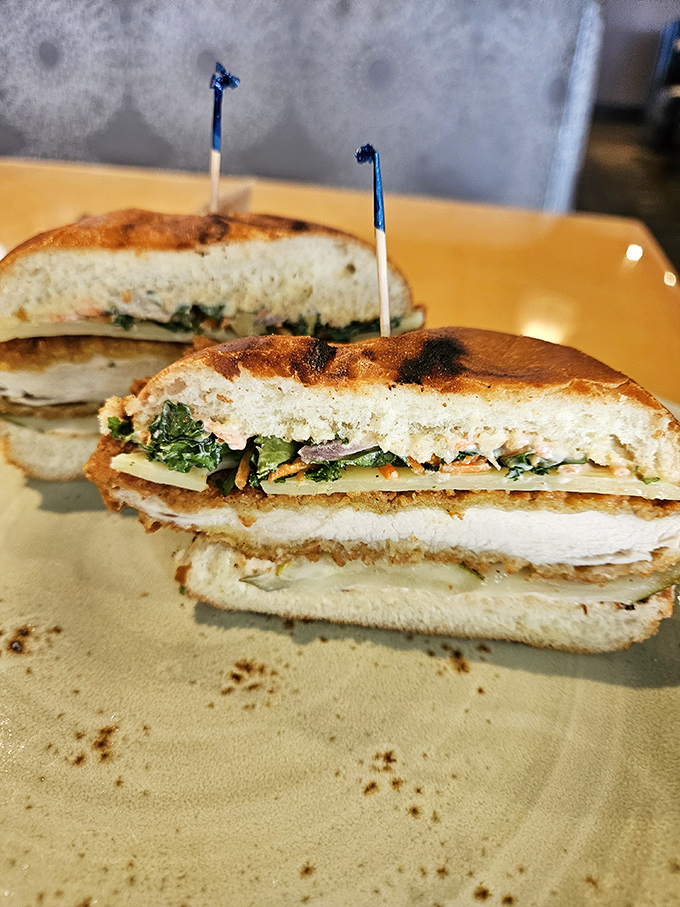 A sandwich cut to reveal its delicious secrets. Like architectural blueprints for the perfect lunch, with layers of flavor instead of drywall.