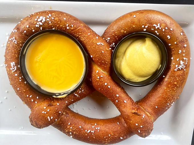 A pretzel that requires both hands and a strategy, served with dipping sauces that make sharing optional but not recommended.