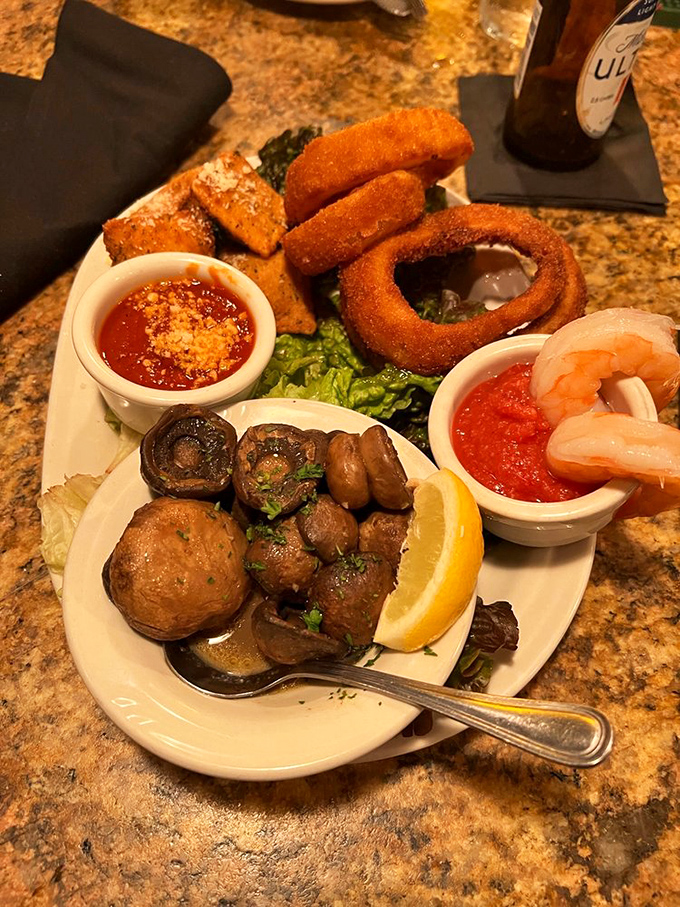 A sampler platter that solves the appetizer dilemma. Crispy ravioli, plump shrimp, and golden onion rings create a Missouri-meets-Mediterranean opening act.