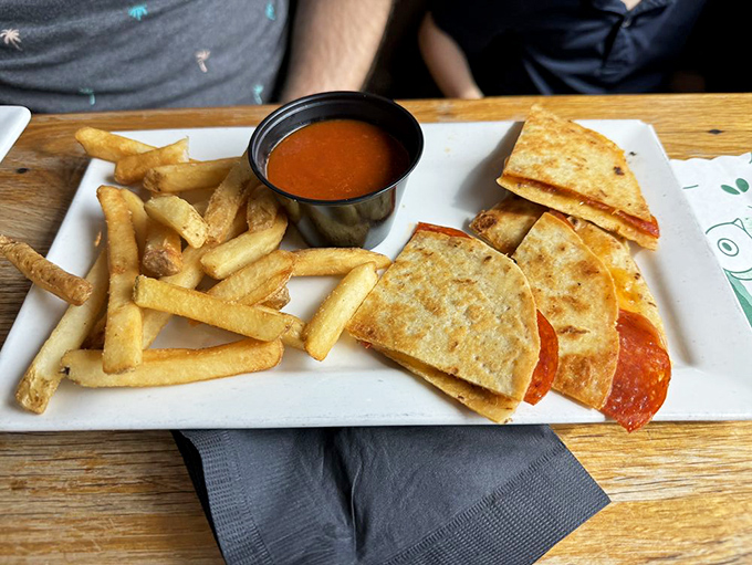 Even the kids' menu refuses to phone it in. This quesadilla-pizza hybrid proves that "children's food" doesn't have to mean "culinary compromise."