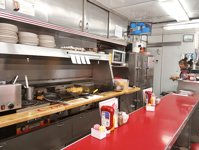 The dance of short-order cooking happens here, where limited space creates unlimited flavor possibilities in full view of appreciative audiences.