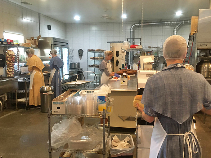 Bakers in their natural habitat, moving with the choreographed precision that comes from turning flour and sugar into joy for a living.