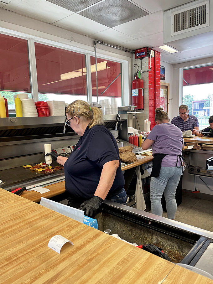 The grill masters at work, conducting a symphony of sizzles that has drawn standing ovations from generations of Missouri burger lovers.