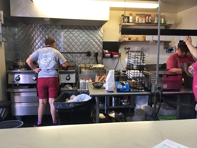 Kitchen choreography at its finest &ndash; where magic happens on a well-seasoned grill that's probably older than most cars on the road.