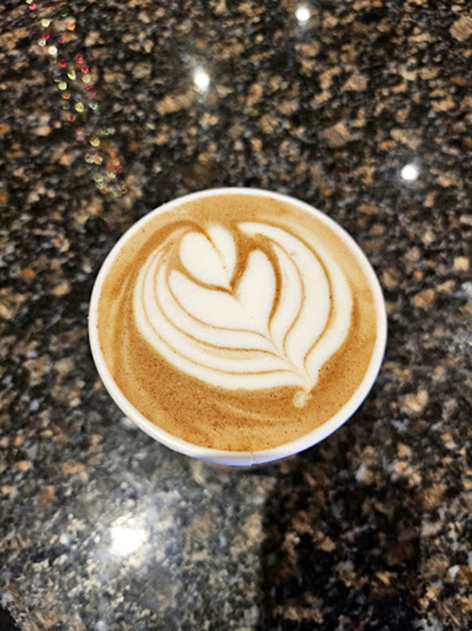 Coffee art so precise you'd think the barista trained under Michelangelo. That foam leaf is practically photosynthesizing!