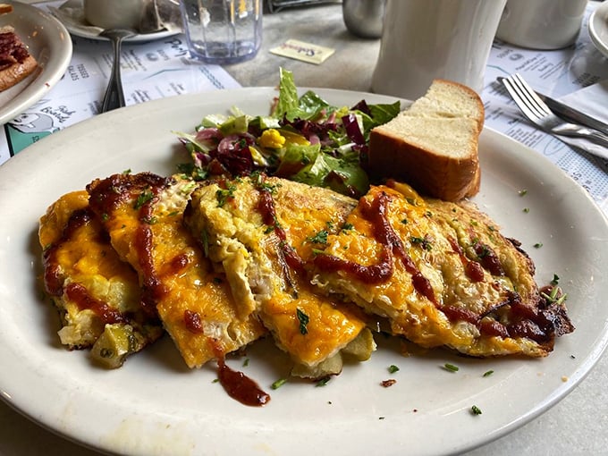 Breakfast doesn't get more beautiful than this golden omelet. The melted cheese and sauce create a morning masterpiece worthy of frame.