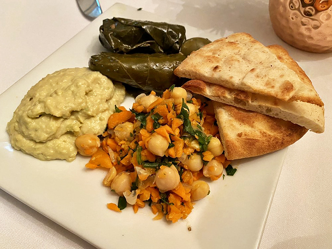 Mediterranean vacation on a plate! Hummus, dolmas, and chickpea salad create a mezze platter that's like a passport for your palate.