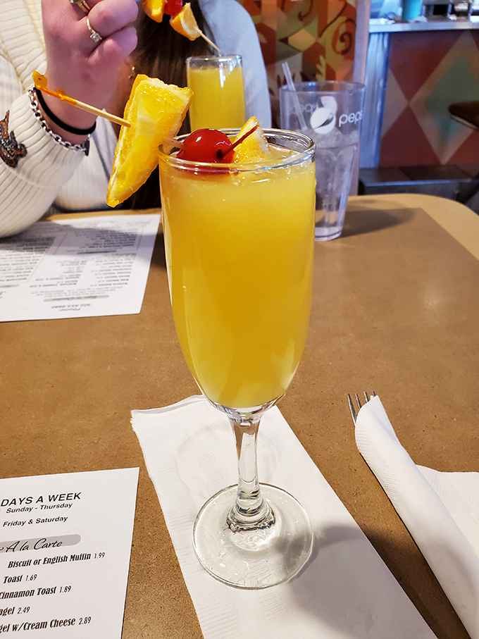 A mimosa that says, "Yes, it's technically morning, but let's make it festive." Sunshine in a glass with a cherry on top.