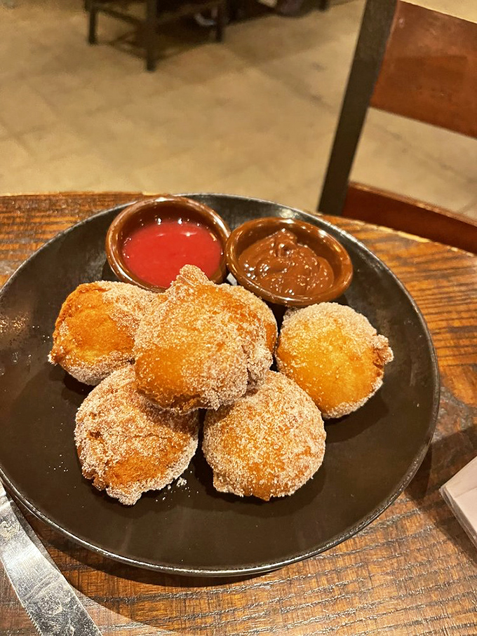 Mini donuts arrive like sugary meteors from a parallel universe where desserts are taken as seriously as the main event.