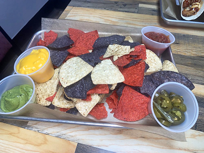 A rainbow of chips with dips standing by for duty. The jalape&ntilde;os are there for those brave enough to accept their spicy challenge. 