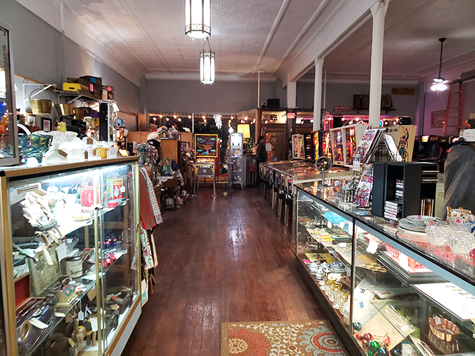 Vintage clothing hangs alongside mid-century furniture in this basement section, where that bright red suitcase practically begs to be taken on a new adventure.