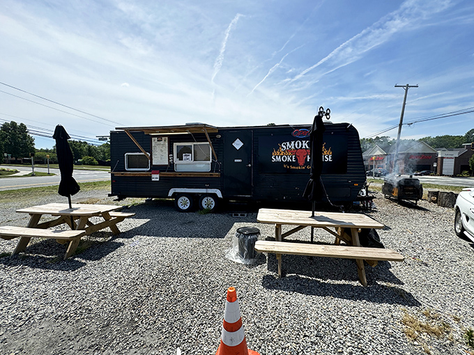 Picnic tables outside the smokehouse: where strangers become friends united by sauce-stained napkins and mutual appreciation.