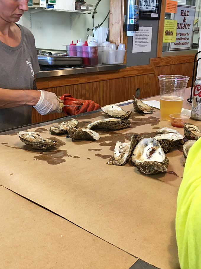 The art of oyster shucking &ndash; where skill meets freshness. That gloved hand knows exactly what it's doing.