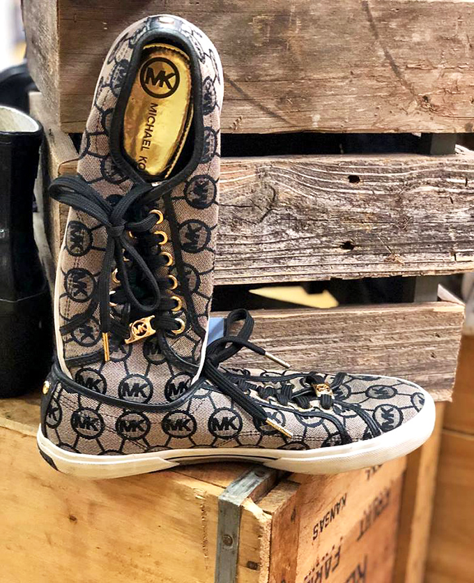 Michael Kors sneakers perched on vintage crates&mdash;high fashion meets down-home display in a perfect thrifting paradox. 