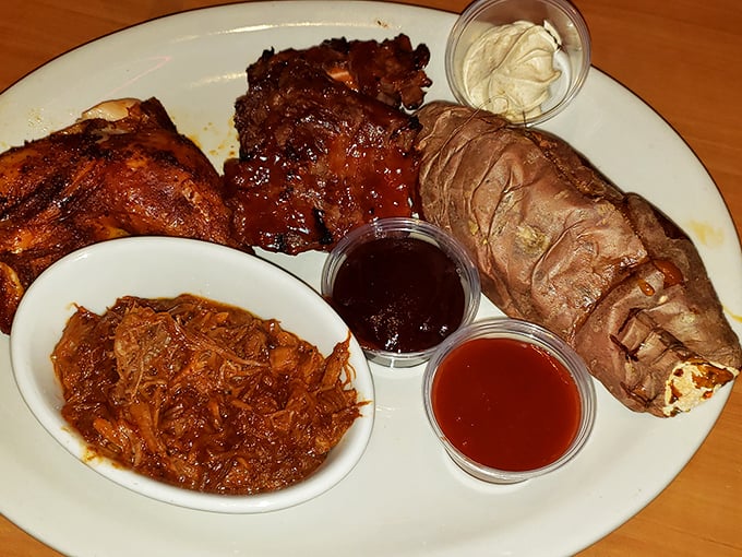 A barbecue quartet performing their greatest hits: pulled pork, chicken, ribs, and brisket, with sauce cups conducting this meaty symphony.