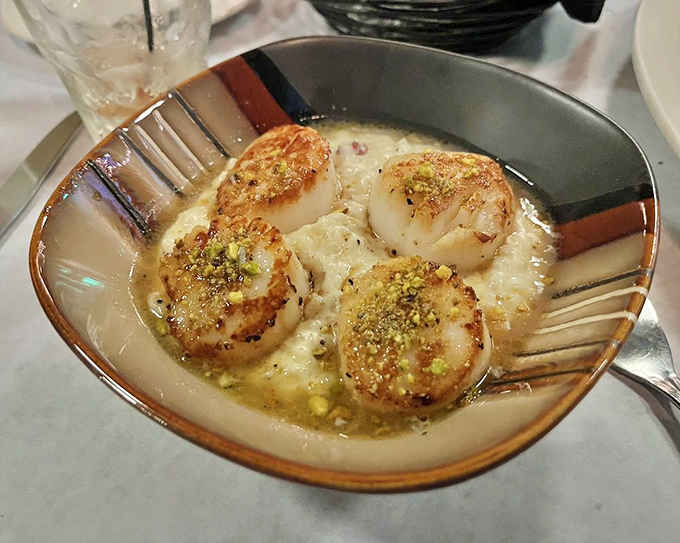These perfectly seared scallops swimming in butter sauce aren't just dinner &ndash; they're edible proof that life is worth celebrating, preferably with a good white wine.