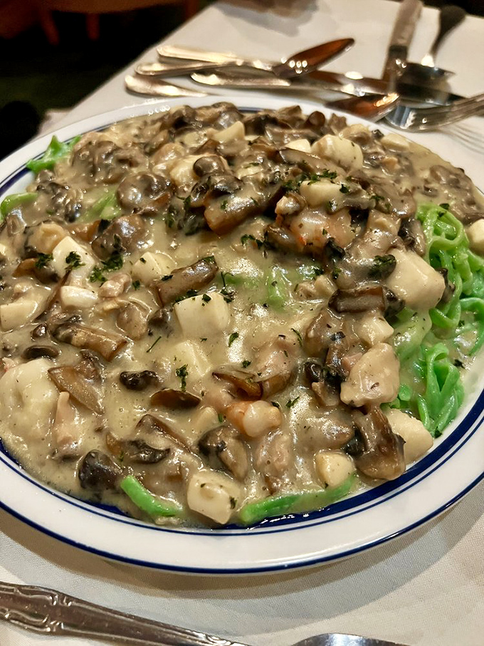 Green pasta playing hide and seek under a creamy mushroom blanket. Comfort food that somehow manages to feel sophisticated.