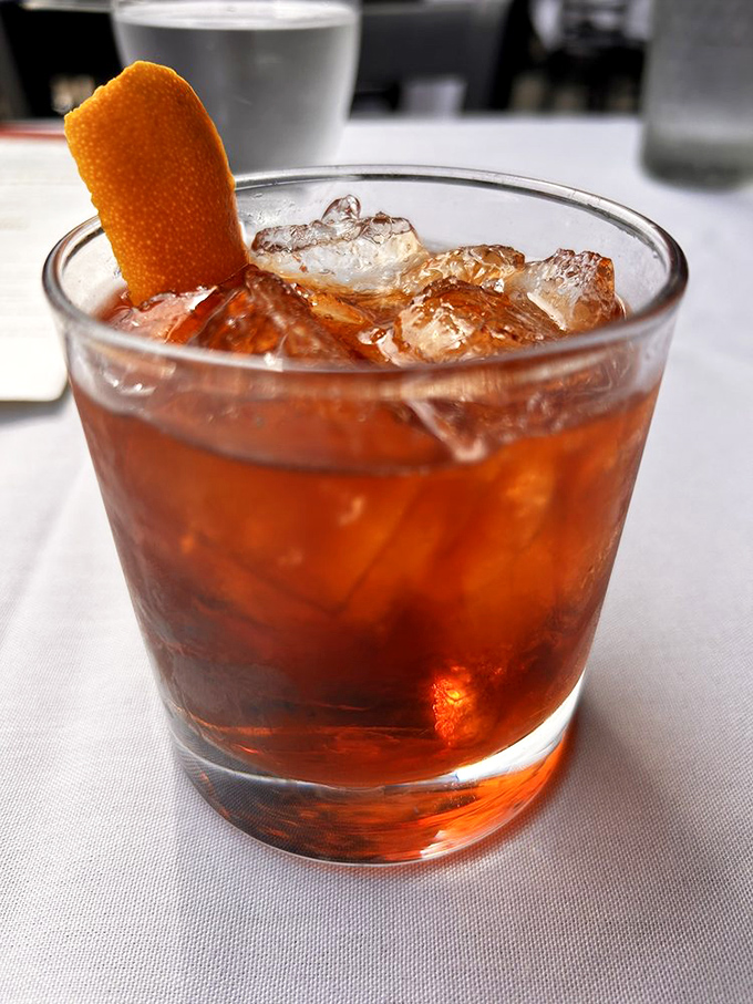 This Negroni isn't just a drink&mdash;it's a sunset in a glass with an orange peel twist that says "sophistication" without showing off.