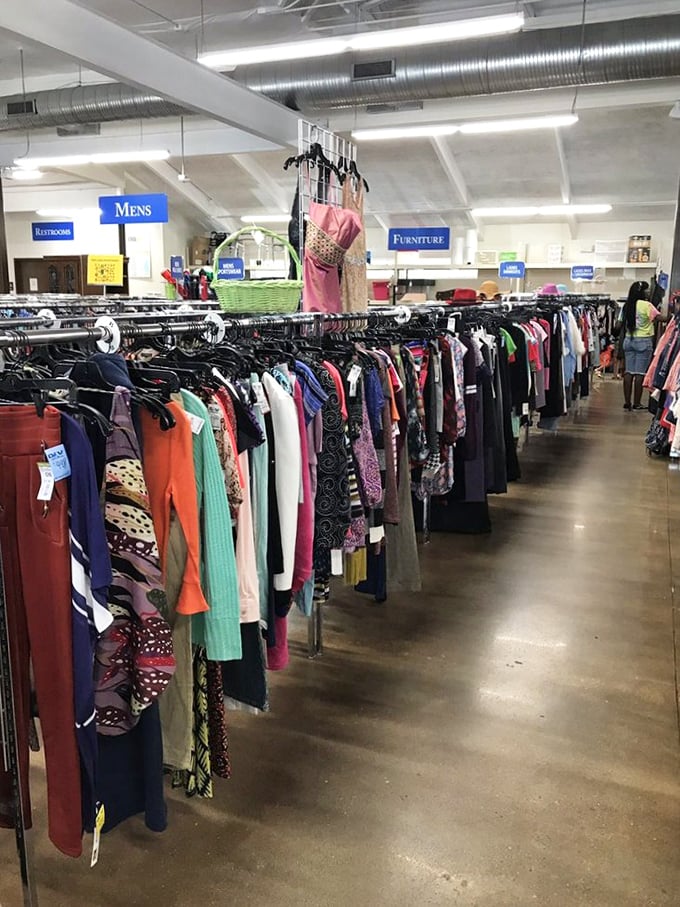 A colorful parade of possibilities hangs in perfect formation, with the "Mens" section sign standing guard like a retail traffic cop.