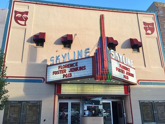 The Skyline Theatre's neon marquee promises entertainment at yesterday's prices. First-run movies with buttered popcorn that doesn't require a small loan.