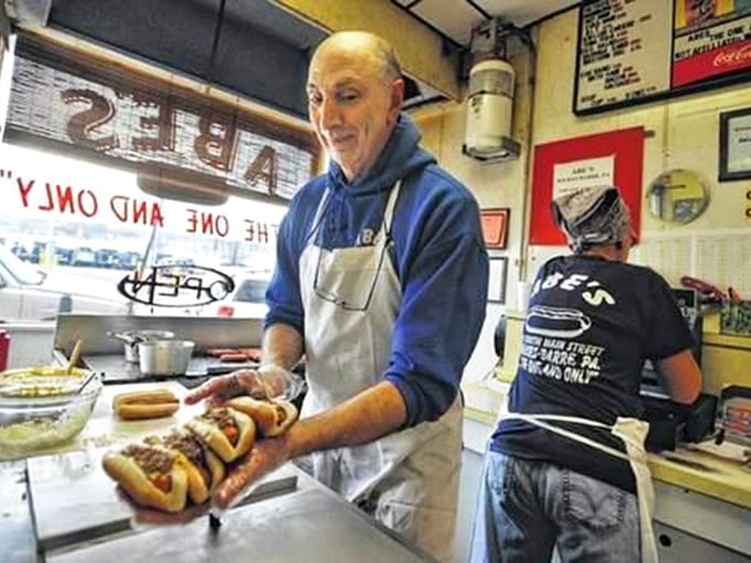 Behind every great hot dog is someone who's mastered the art of simplicity. That knowing smile says, "Just wait till you taste this." 