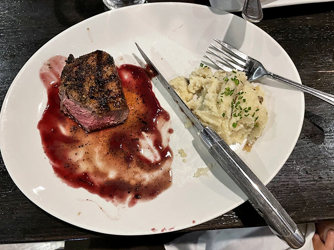 That red wine demi-glace surrounding the filet creates a flavor moat you'll want to explore thoroughly. The mashed potatoes stand ready to assist in the expedition.