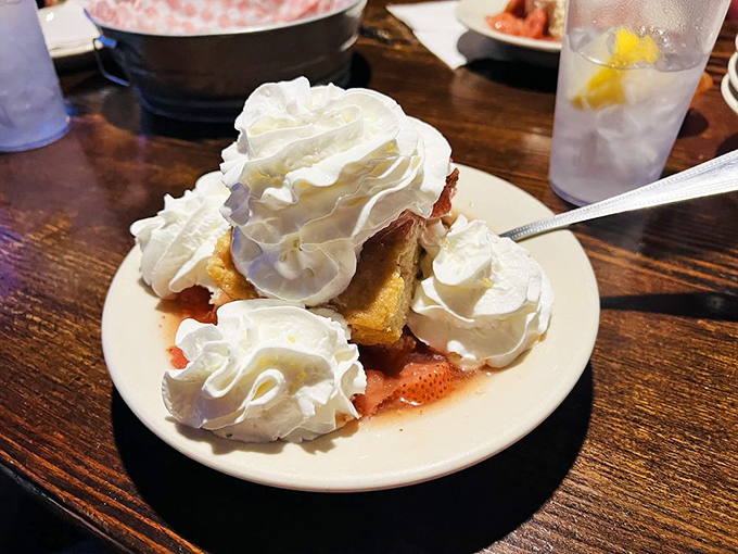 Strawberry shortcake that doesn't know the meaning of restraint—a cloud of whipped cream atop warm cake and juicy berries.