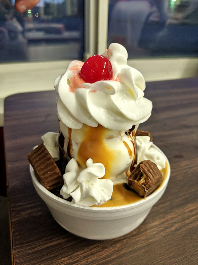 A sundae that defies gravity and good sense&mdash;whipped cream, caramel, and what appears to be the kitchen sink of sweet toppings. P
