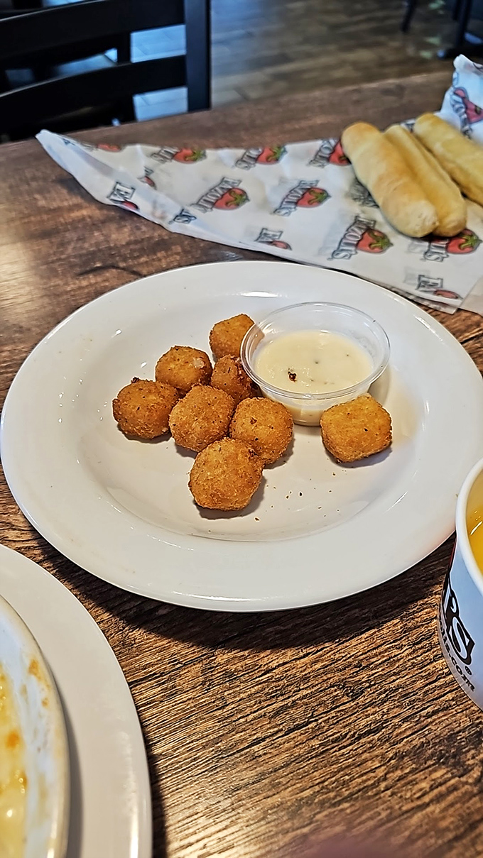 Golden-fried mozzarella bites with dipping sauce: the appetizer that makes you question why we don't start every meal this way.