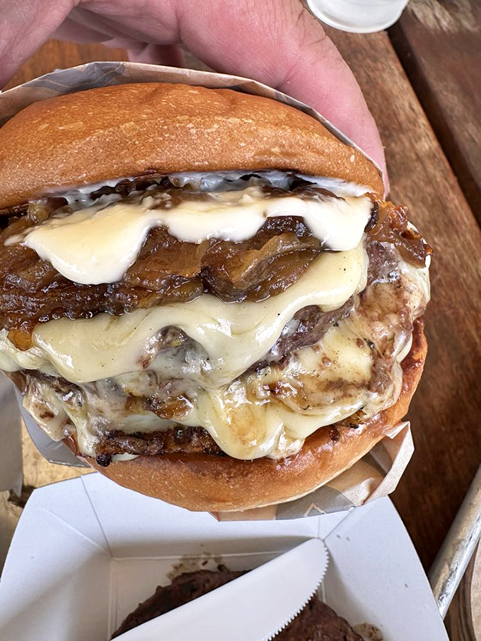 Not just a burger, but a tower of indulgence&mdash;melted cheese and caramelized onions creating a symphony that Mozart would have envied.