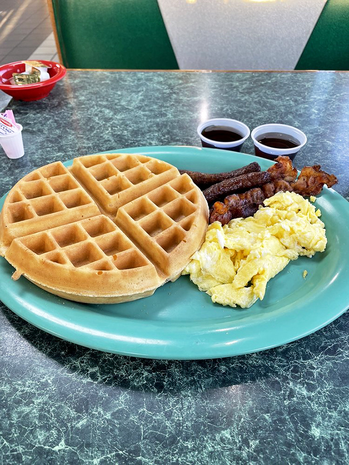 The breakfast trinity&mdash;golden waffle, scrambled eggs, and bacon strips that found the perfect balance between crispy and chewy.