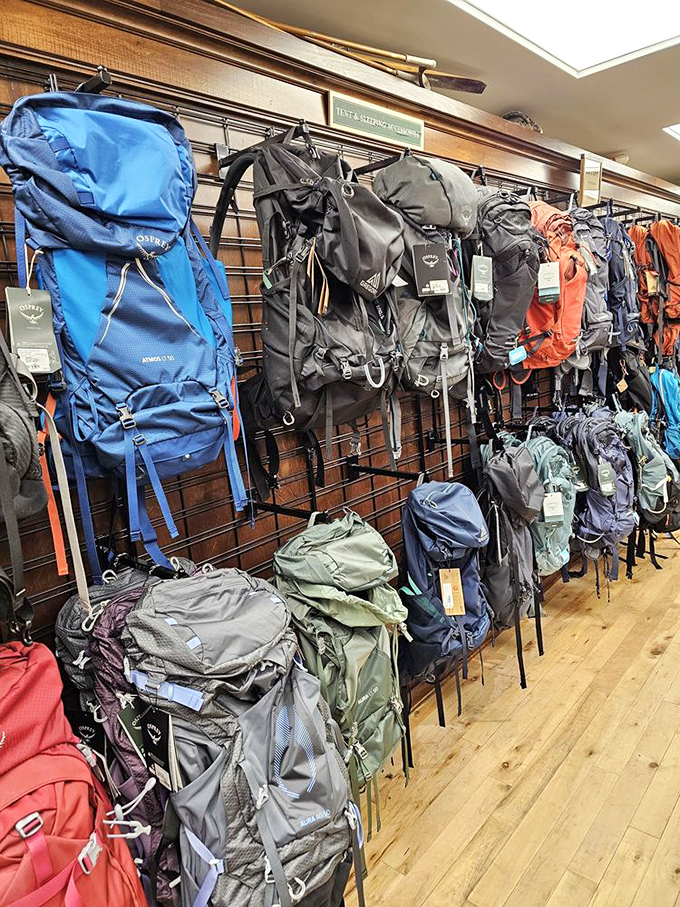 The backpack wall isn't selling bags&mdash;it's offering adventure vessels, each one silently whispering tales of mountain trails yet to be conquered.