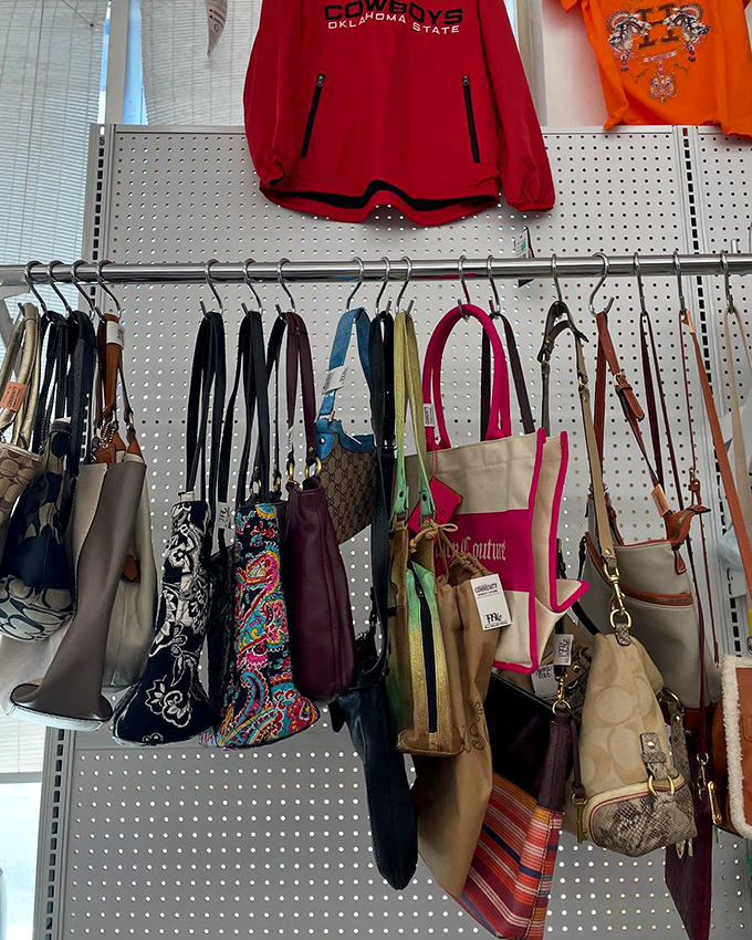 Designer bags mingle with practical totes on this pegboard display. That Juicy Couture number is practically winking at you.
