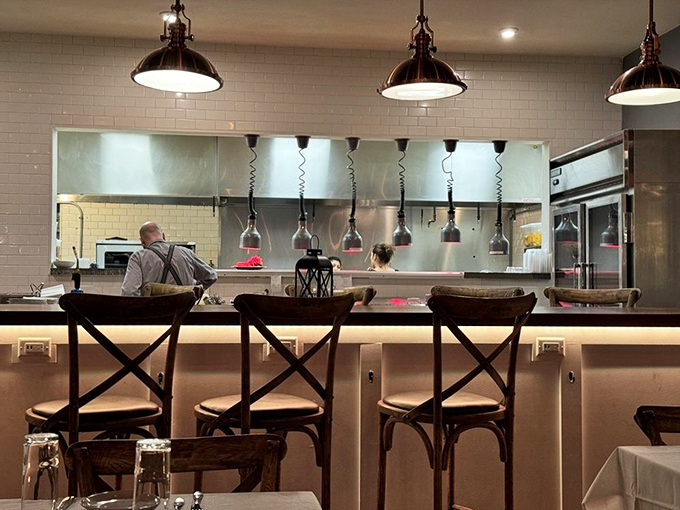 The open kitchen concept isn't just trendy&mdash;it's dinner and a show. Those pendant lights cast the perfect spotlight on culinary craftsmanship in action.