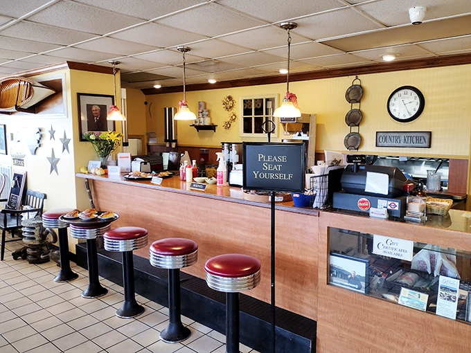 The counter where magic happens—complete with vintage stools and a "Please Seat Yourself" sign that feels like a warm handshake.