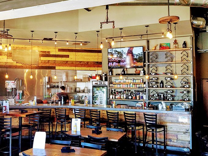 The bar area &ndash; where Oklahoma craft beers flow and food envy happens regularly. That wooden backdrop adds warmth that perfectly matches the hospitality.
