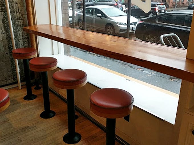 Window seats: where ice cream voyeurs become philosophers. These stools have witnessed first dates, breakups, and countless "just one more bite" promises.
