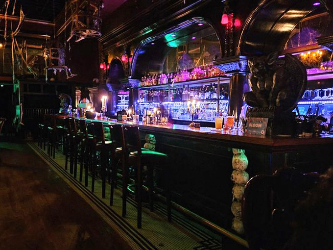 The bar glows with supernatural energy, bottles gleaming like potions waiting to be mixed into something wickedly delicious. 