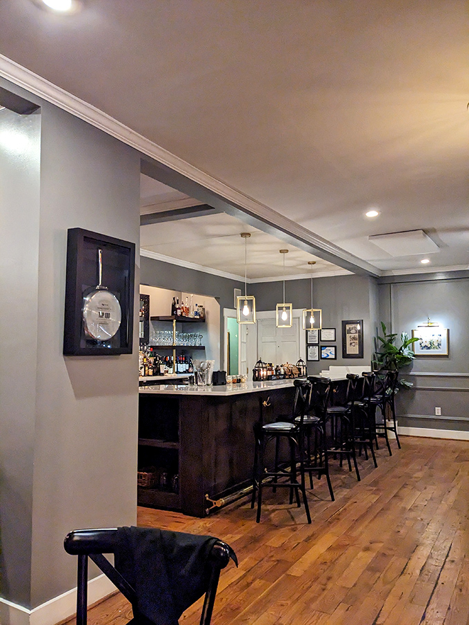 A bar that understands its purpose&mdash;to craft drinks worthy of the food. The marble countertop and pendant lighting create an atmosphere of casual sophistication. 