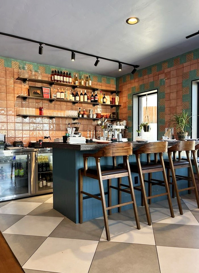 The bar area showcases colorful tile work and warm wood tones, offering a glimpse into Classen Grill's evolution beyond just breakfast.